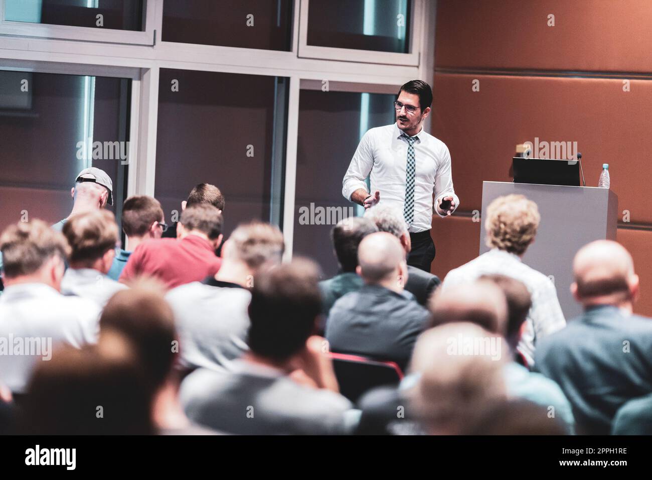 Speaker giving a talk in conference hall at business event. Audience at ...