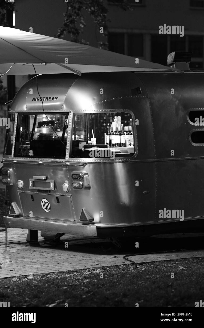 Vertical shot of a retro airstream caravan as food truck at night in ...