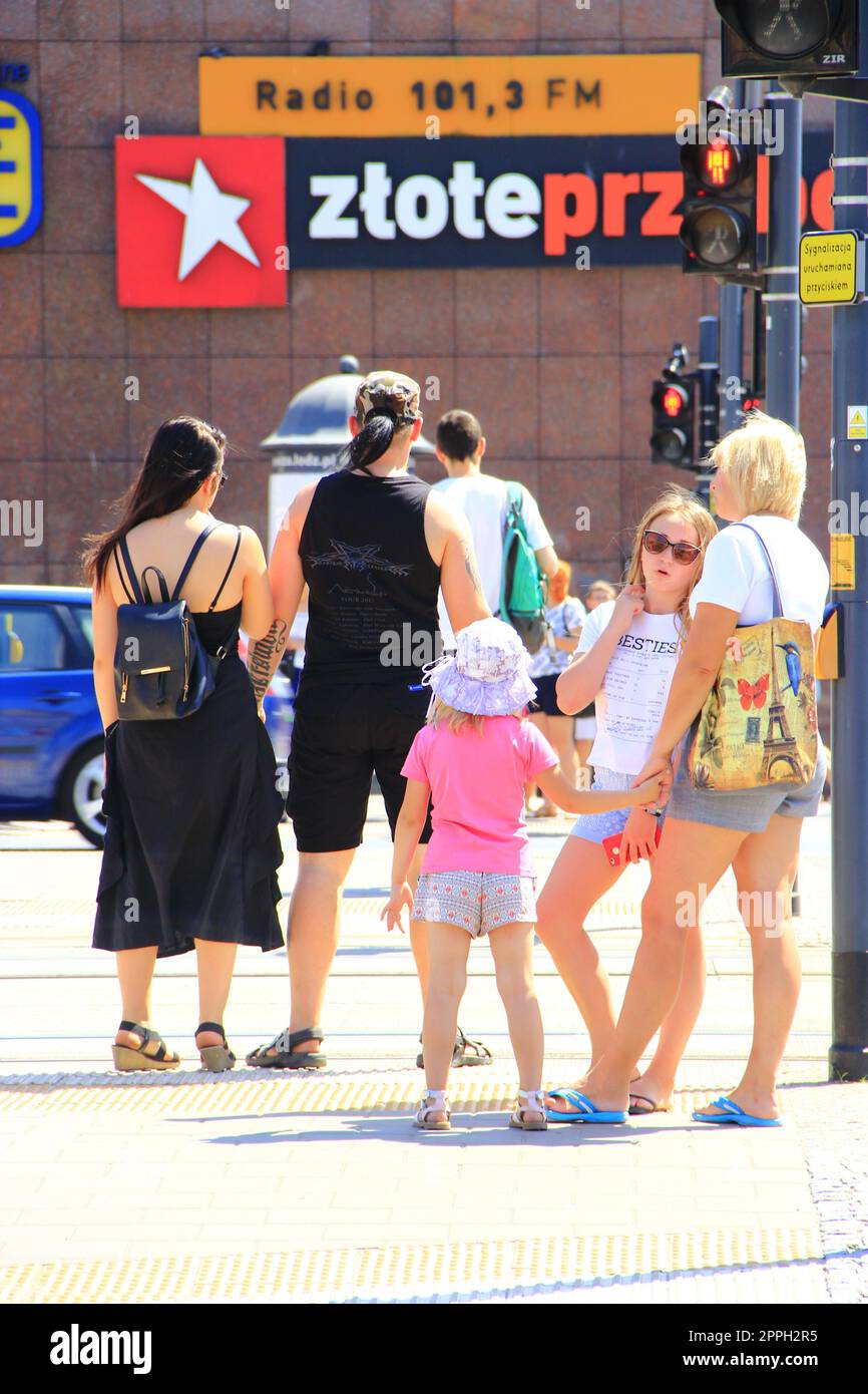 People cross crossroads at pedestrian crossing in city. Rush hour in ...