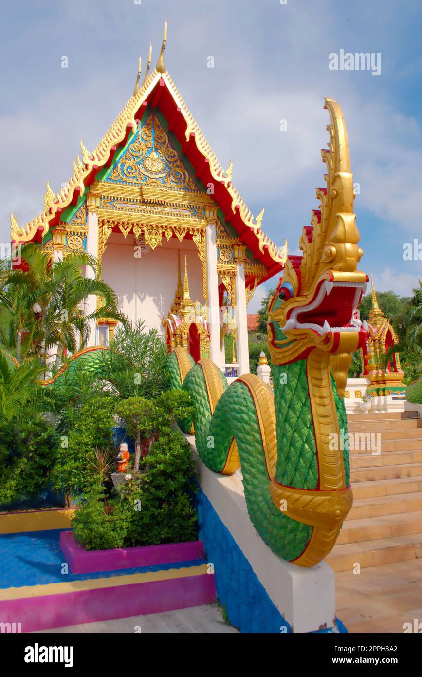 Naga serpent in front of a buddhist chapel at the Wat Suwankiriket ...