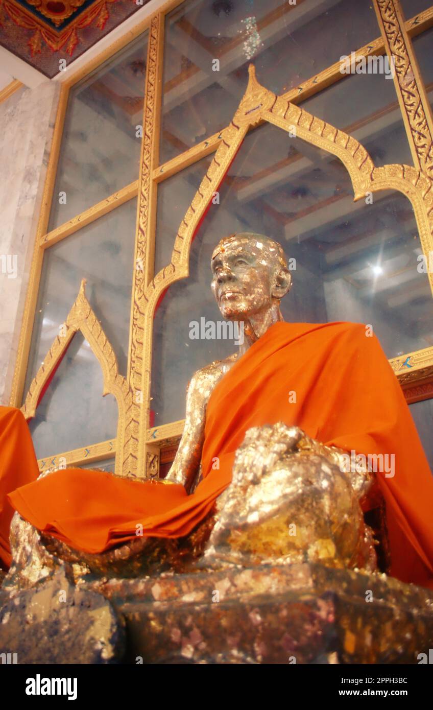 Golden statue of a buddhist monk at Wat Chalong temple, located in ...
