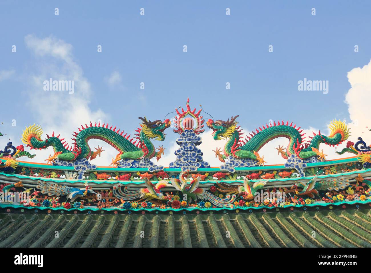 Colorful dragon sculptures on the rooftop of a chines buddhist temple ...