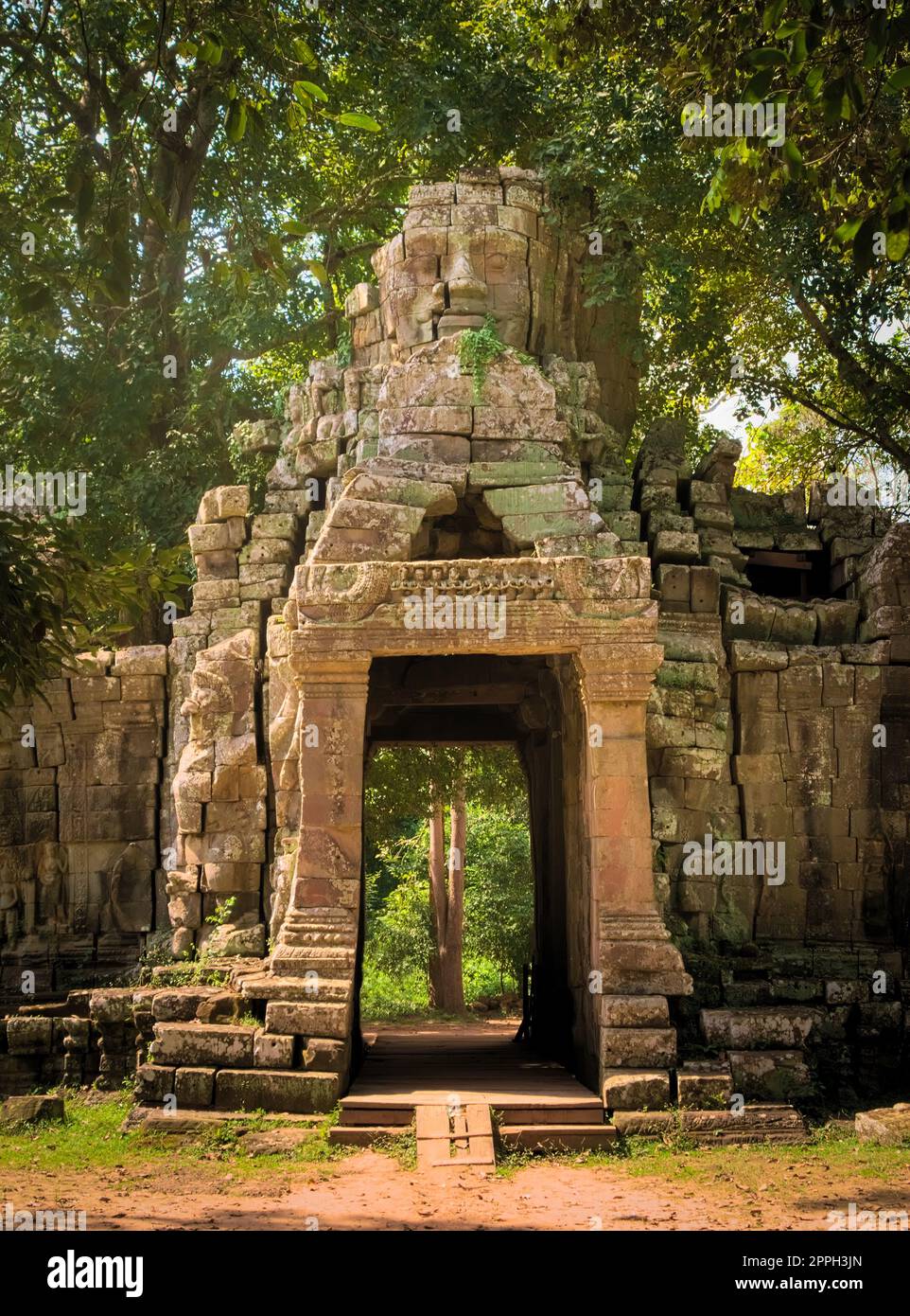 Stone face tower over the outer entrance gate of Ta Prohm temple ...
