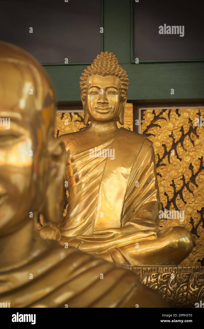 Golden statue of buddha in the lotus position at a temple in Siem Reap ...