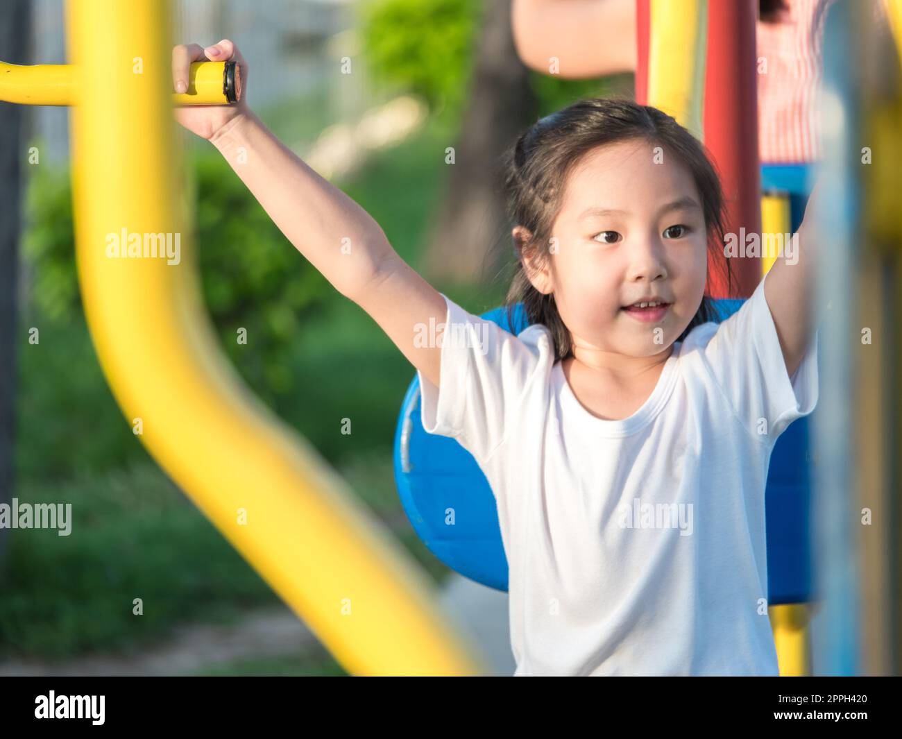 Happy asian baby child playing on playground , exercise equipment in ...