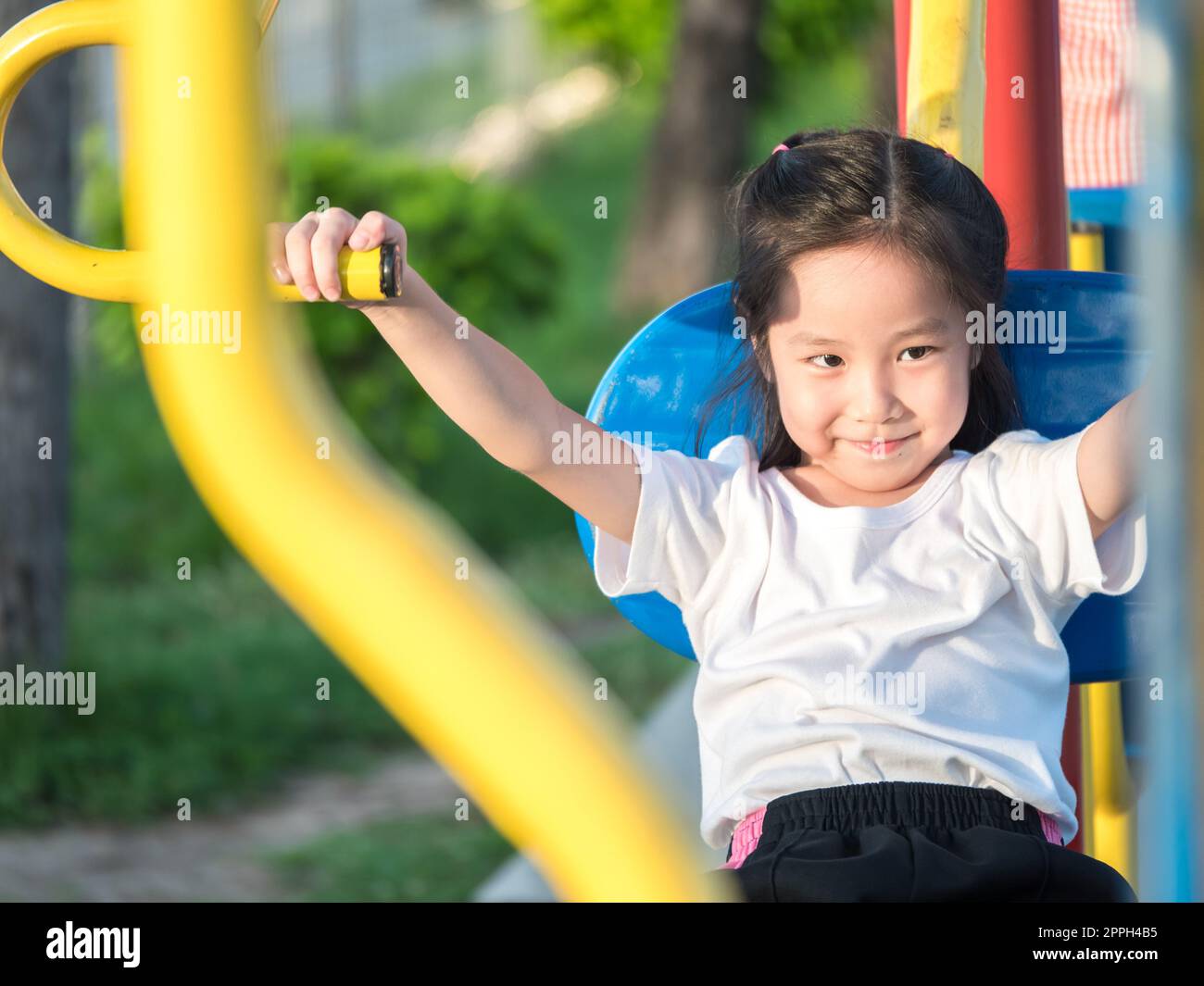 Happy asian baby child playing on playground , exercise equipment in ...