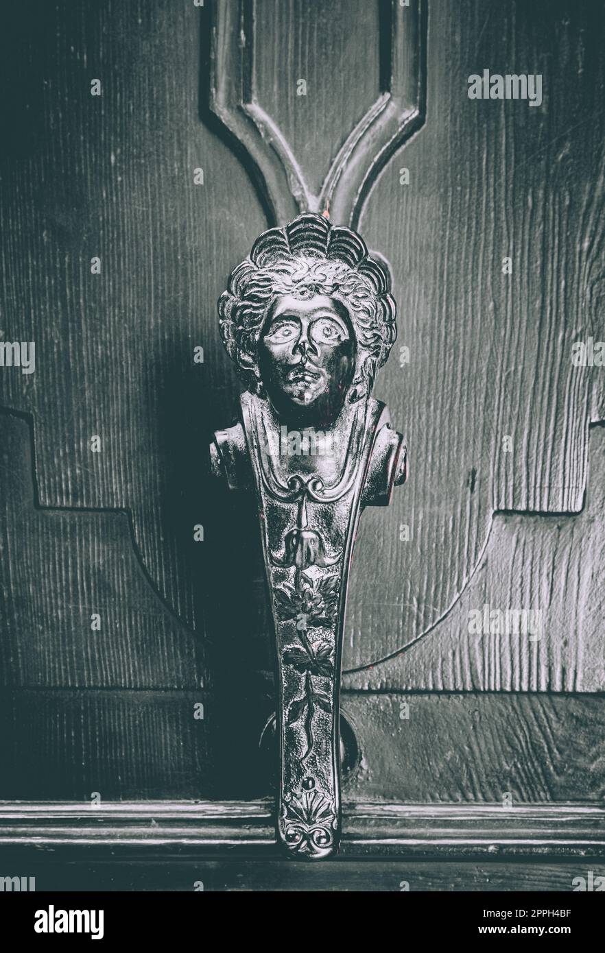 Interesting human face door knocker on a door in one of the back ...