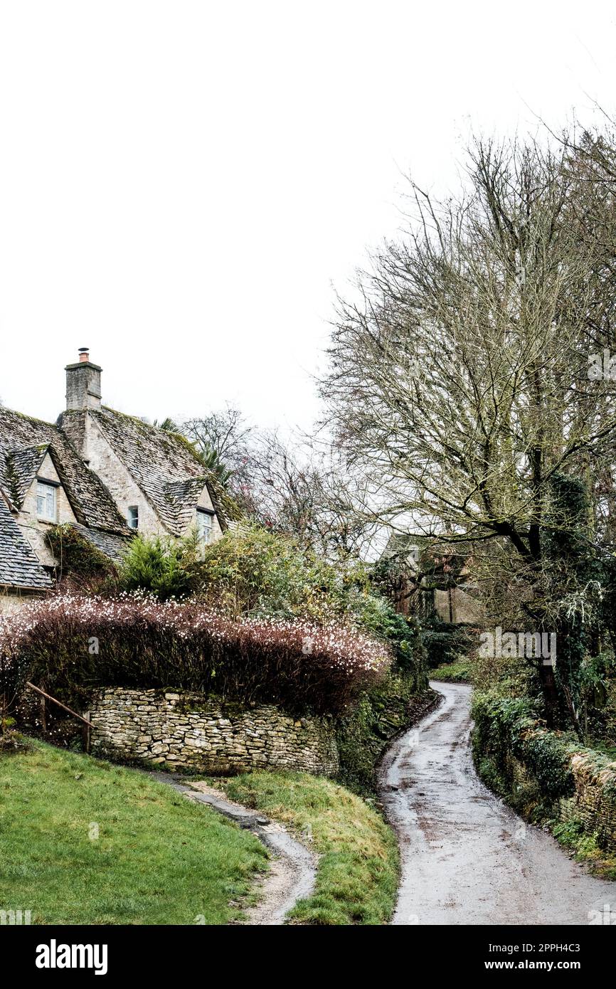 Winding country lane in The Cotswold village of Bibury, Glouctershire Stock Photo - Alamy