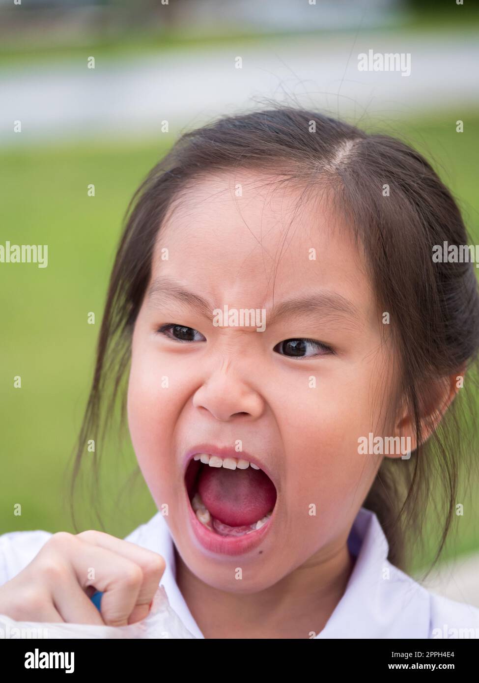 Asian little girl feel angry, head shot composition Stock Photo - Alamy