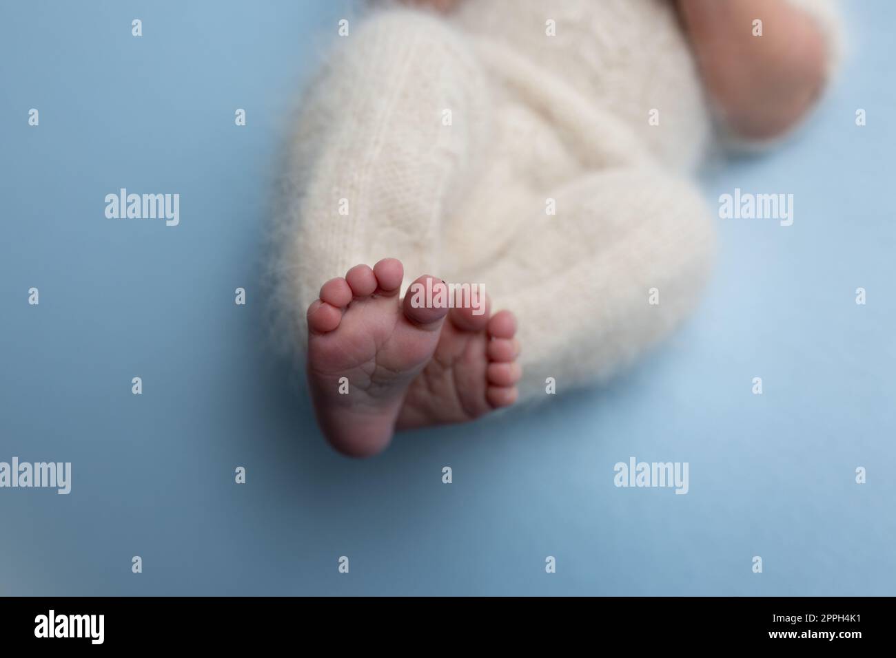 twisted child. Soft feet of a newborn Stock Photo - Alamy