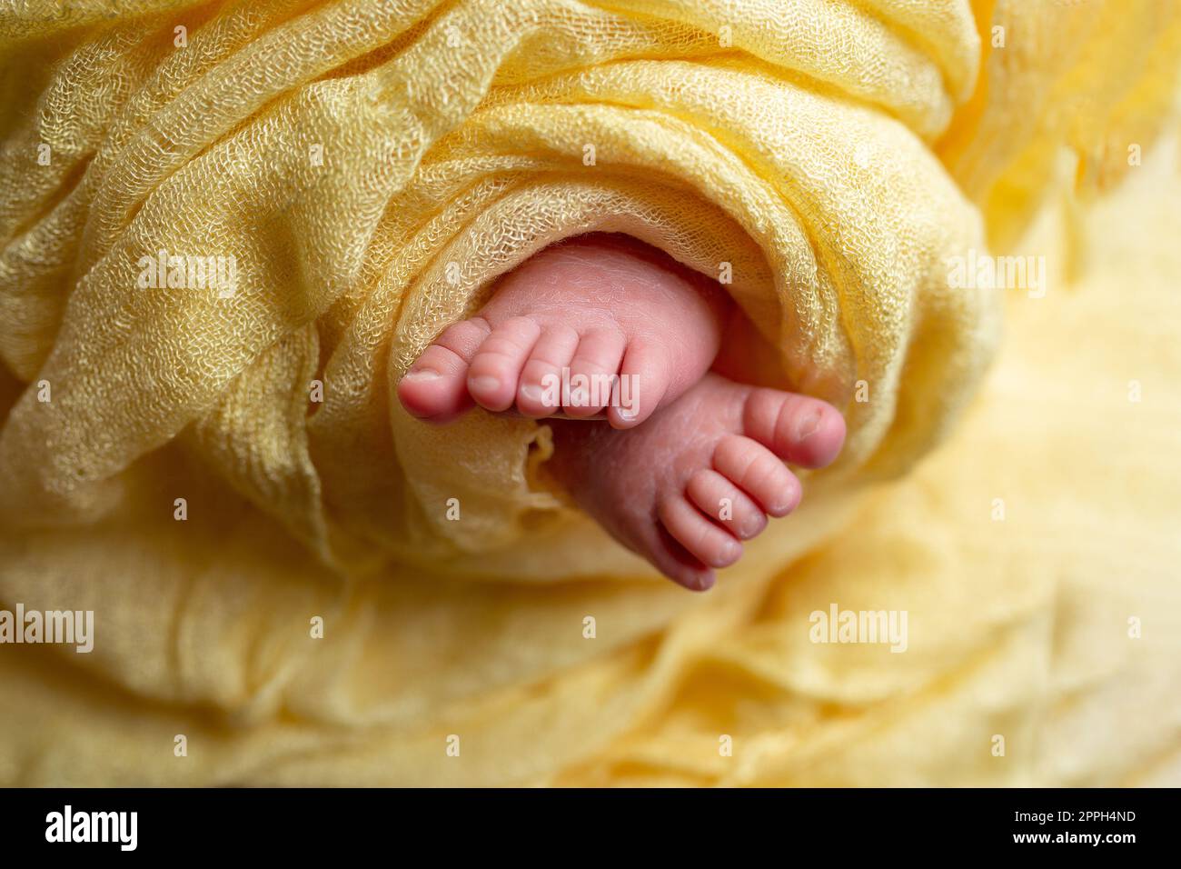 twisted child. Soft feet of a newborn Stock Photo - Alamy
