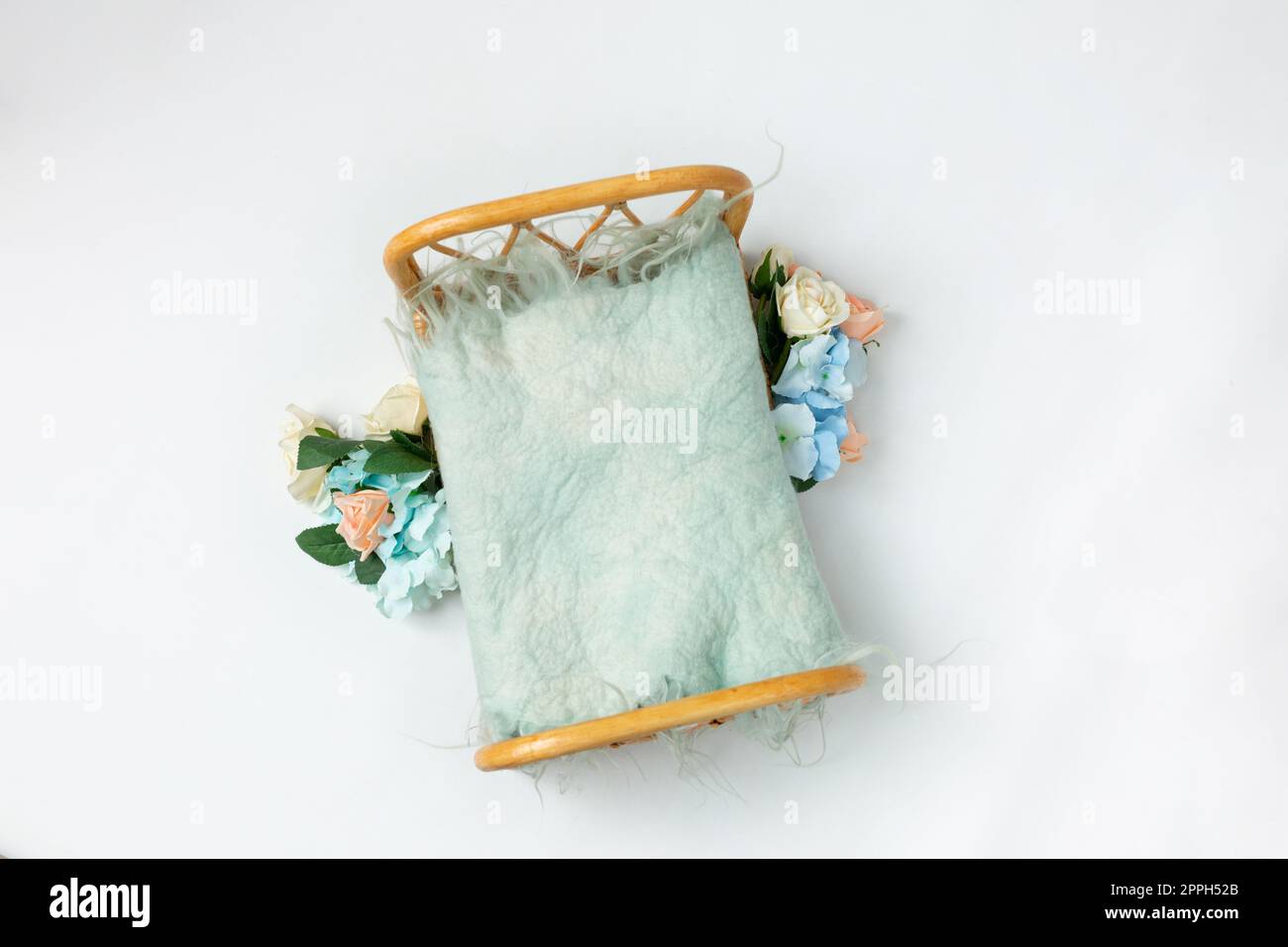 a small bed decorated with flowers. cot for a newborn photo shoot ...