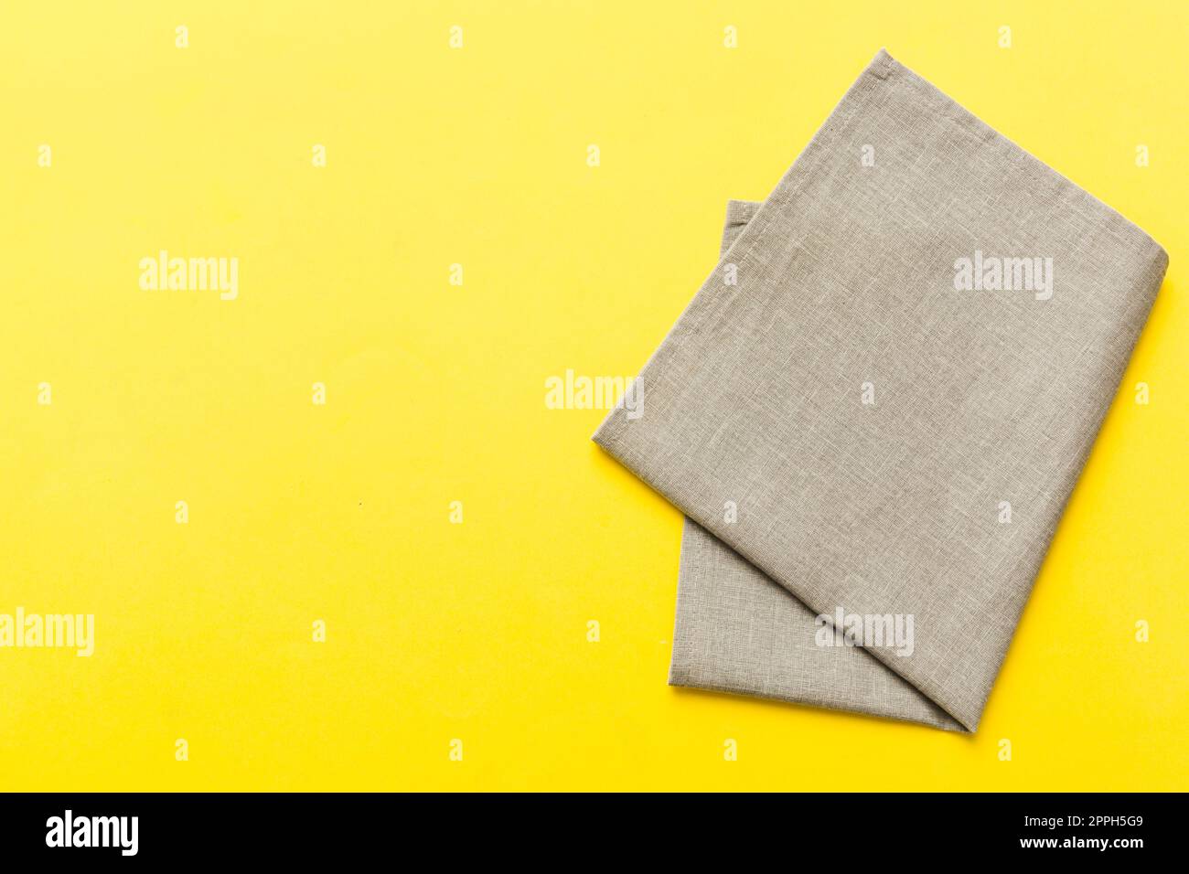 top view with gray kitchen napkin isolated on table background. Folded ...