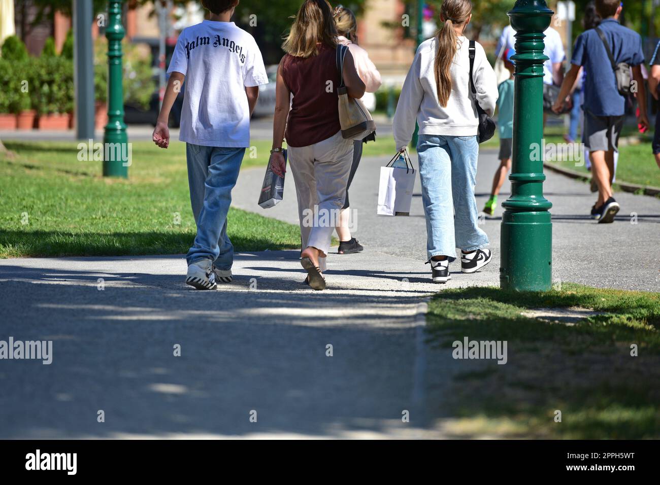 Street scene with many people from behind Stock Photo - Alamy