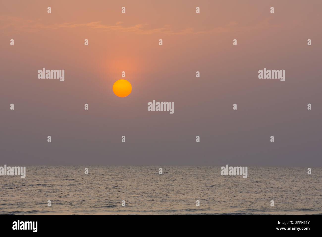 bright orange sun at the beach on vacation Stock Photo - Alamy