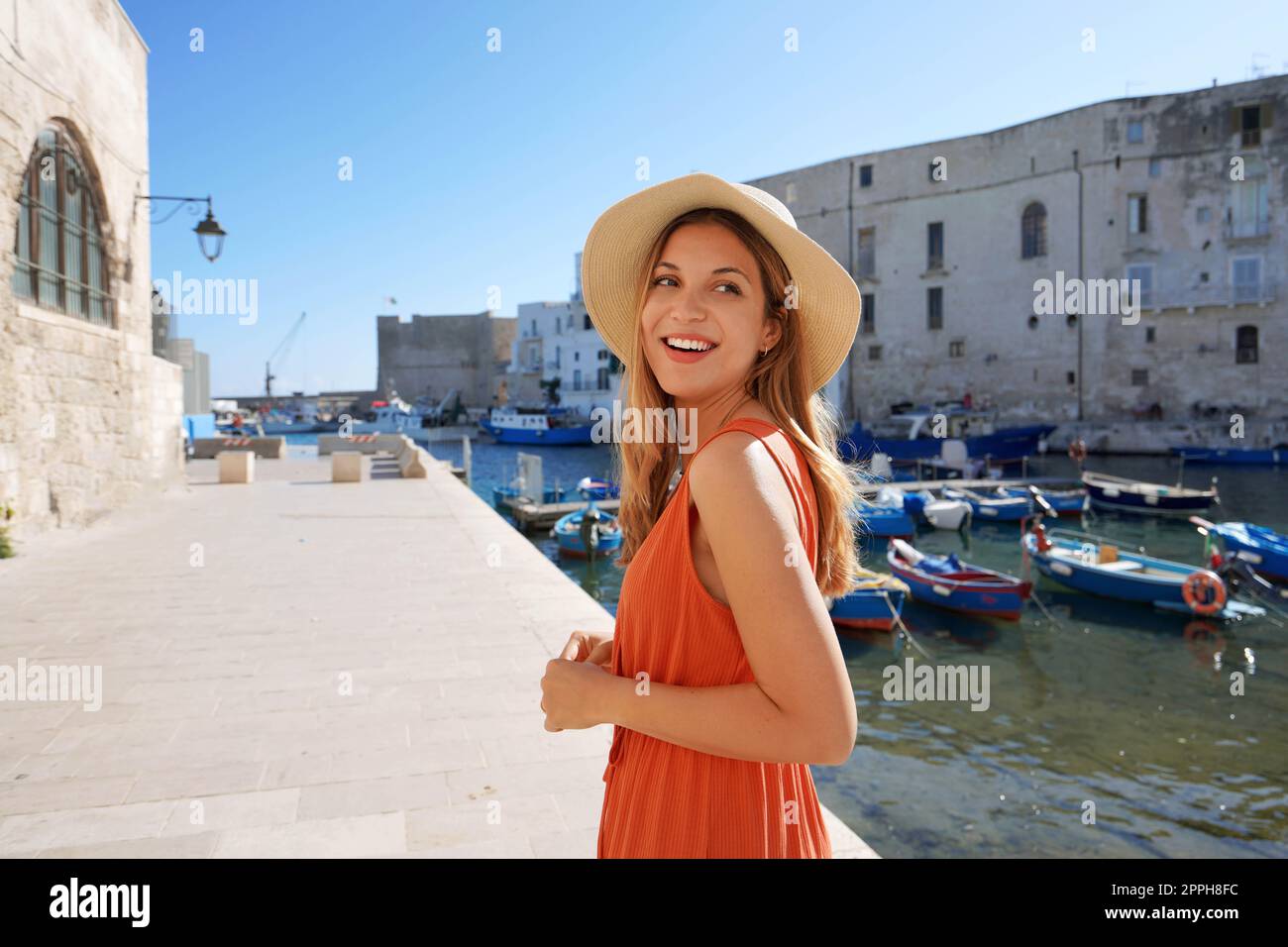 Young tourist woman in the ancient town and port of Monopoli, Apulia ...