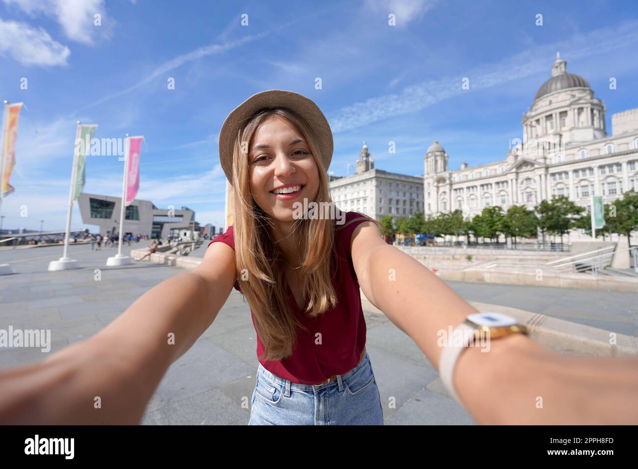Tourism in Liverpool, UK. Beautiful young woman takes selfie picture in ...