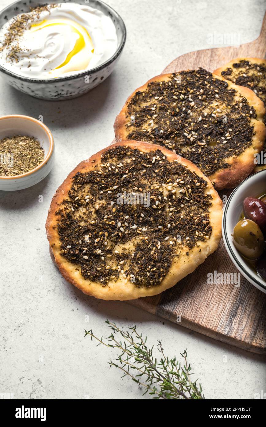 Manakeesh, arabic pizza, flat bread topped with zaatar spices close up ...