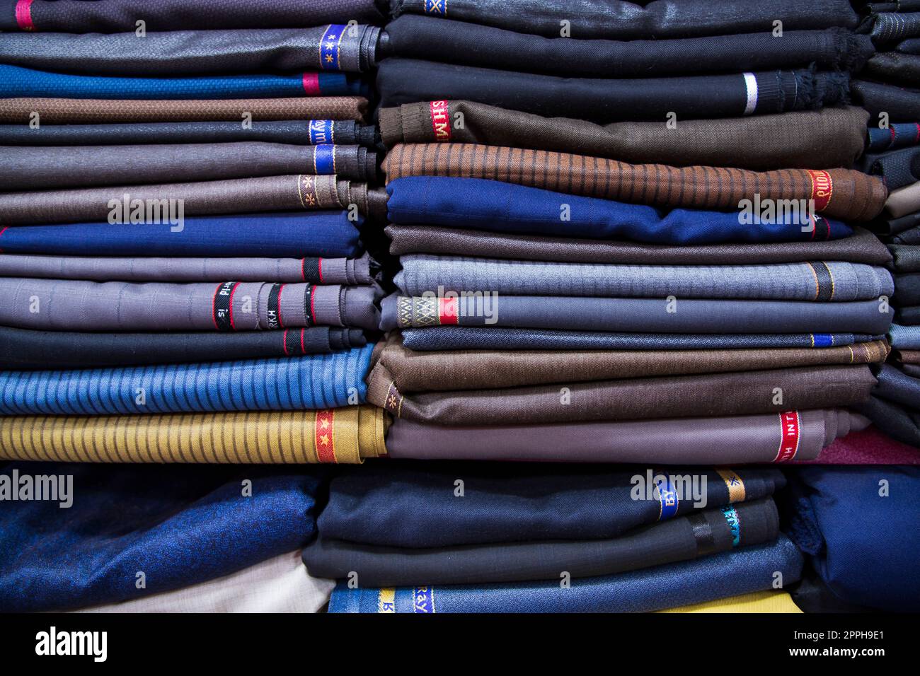 Patterned Textile Fabrics stacked on a retail Shop Shelf for sale Stock ...