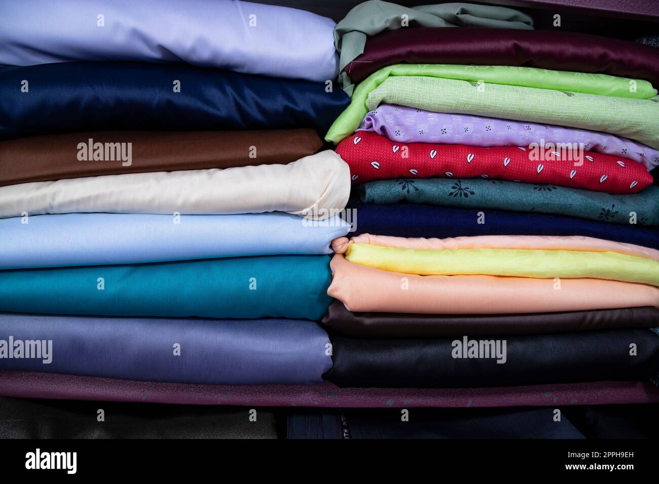 Patterned Textile Fabrics stacked on a retail Shop Shelf for sale Stock ...