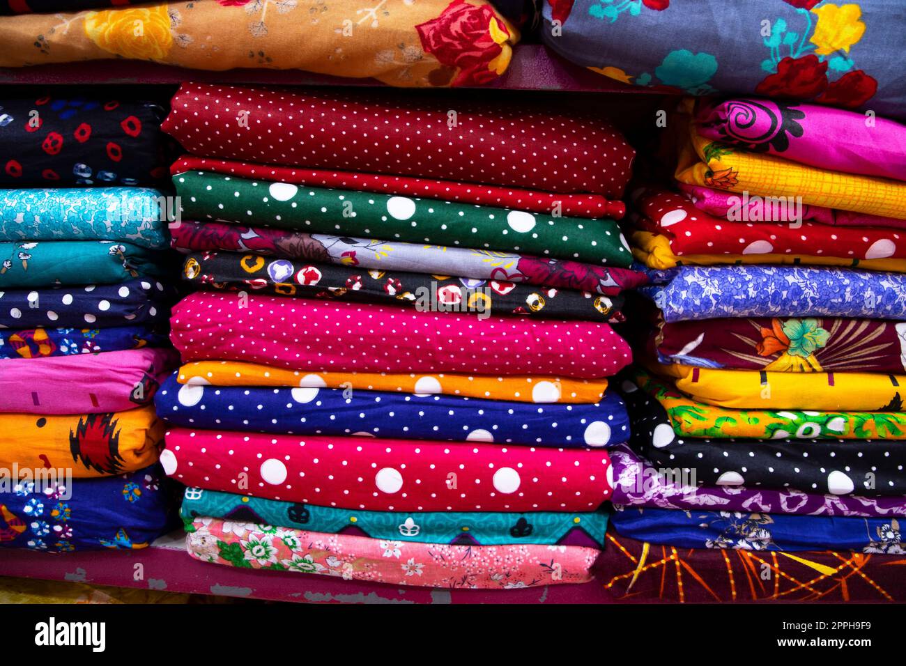 Artistic variety shade tone colors Textile Fabrics stacked on retail ...