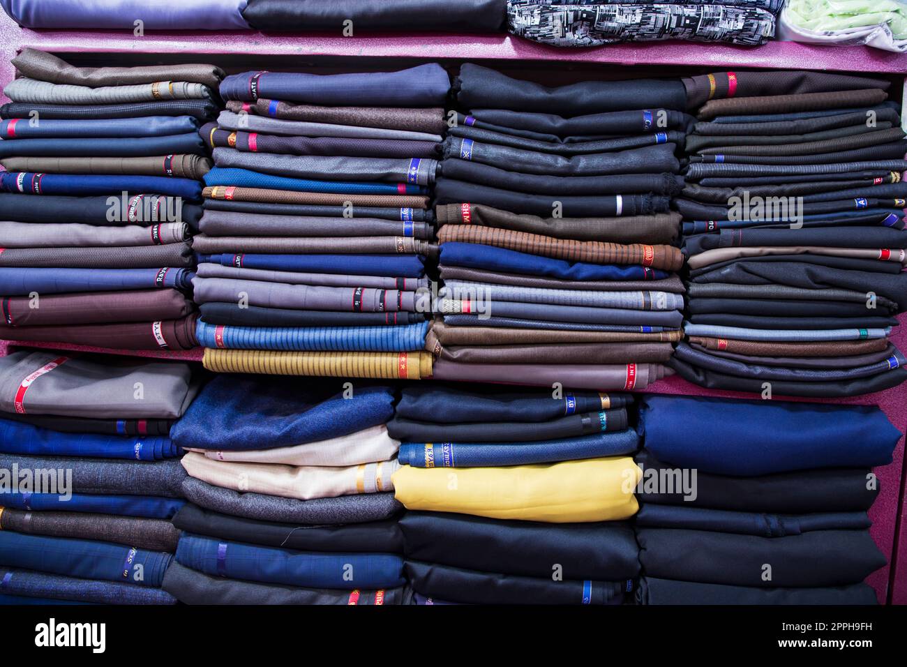 Patterned Textile Fabrics stacked on a retail Shop Shelf for sale Stock ...