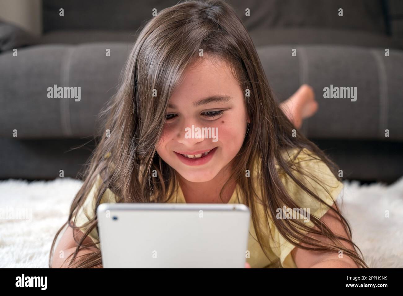 Cute little girl using tablet hi-res stock photography and images - Alamy
