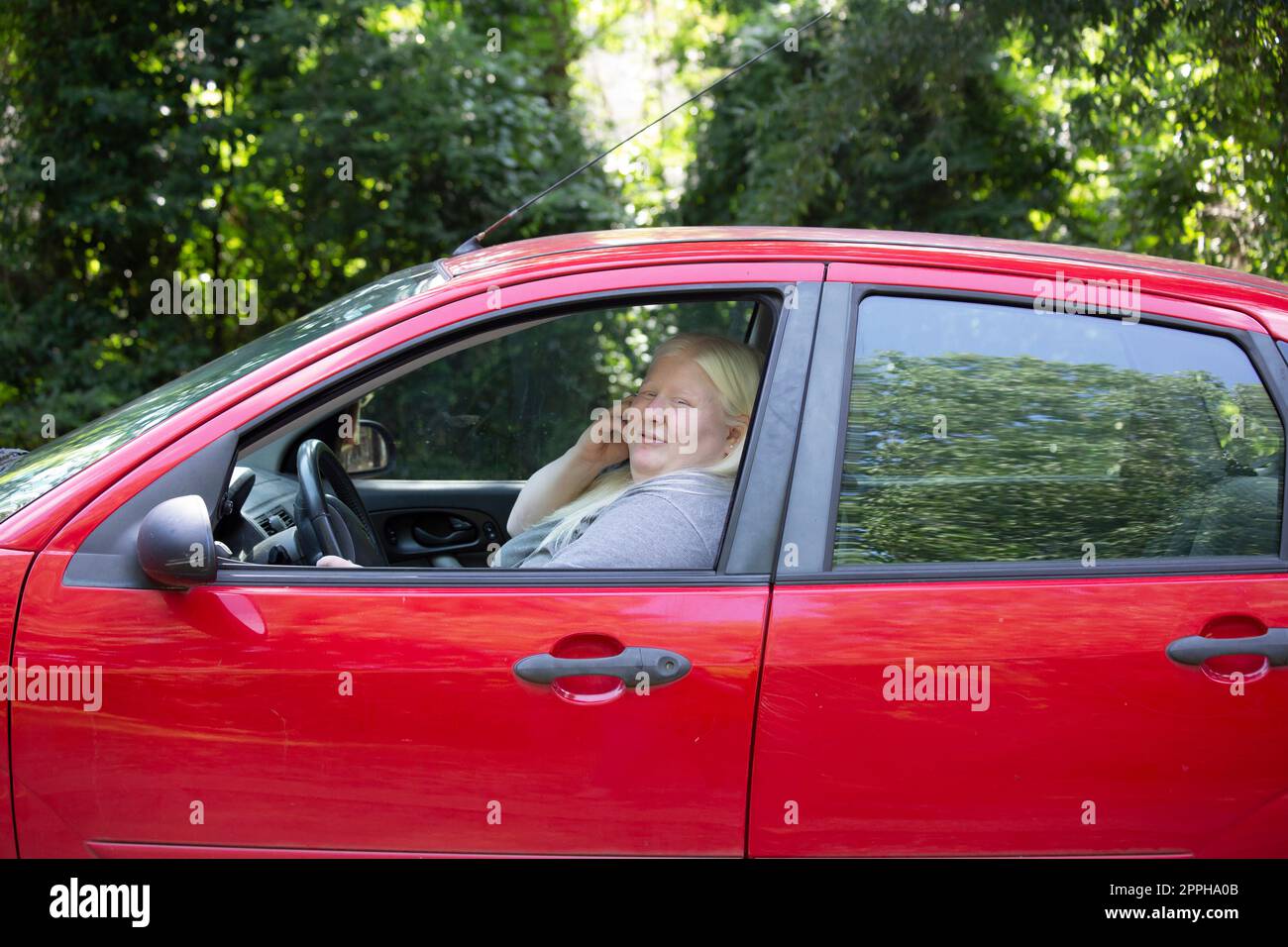 Woman driving red car hi-res stock photography and images - Alamy