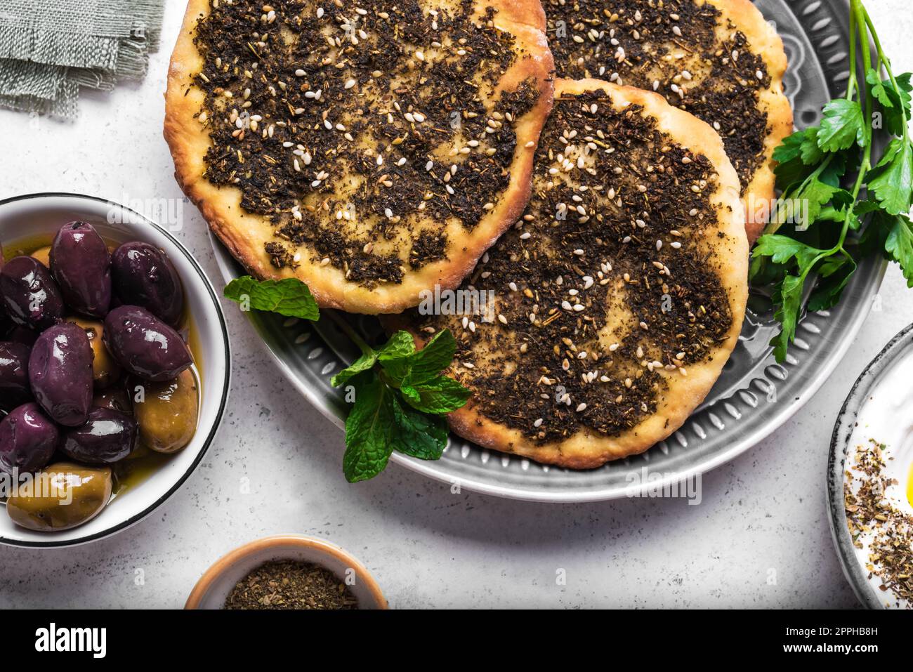 Manakeesh, arabic pizza, flat bread topped with zaatar spices close up ...