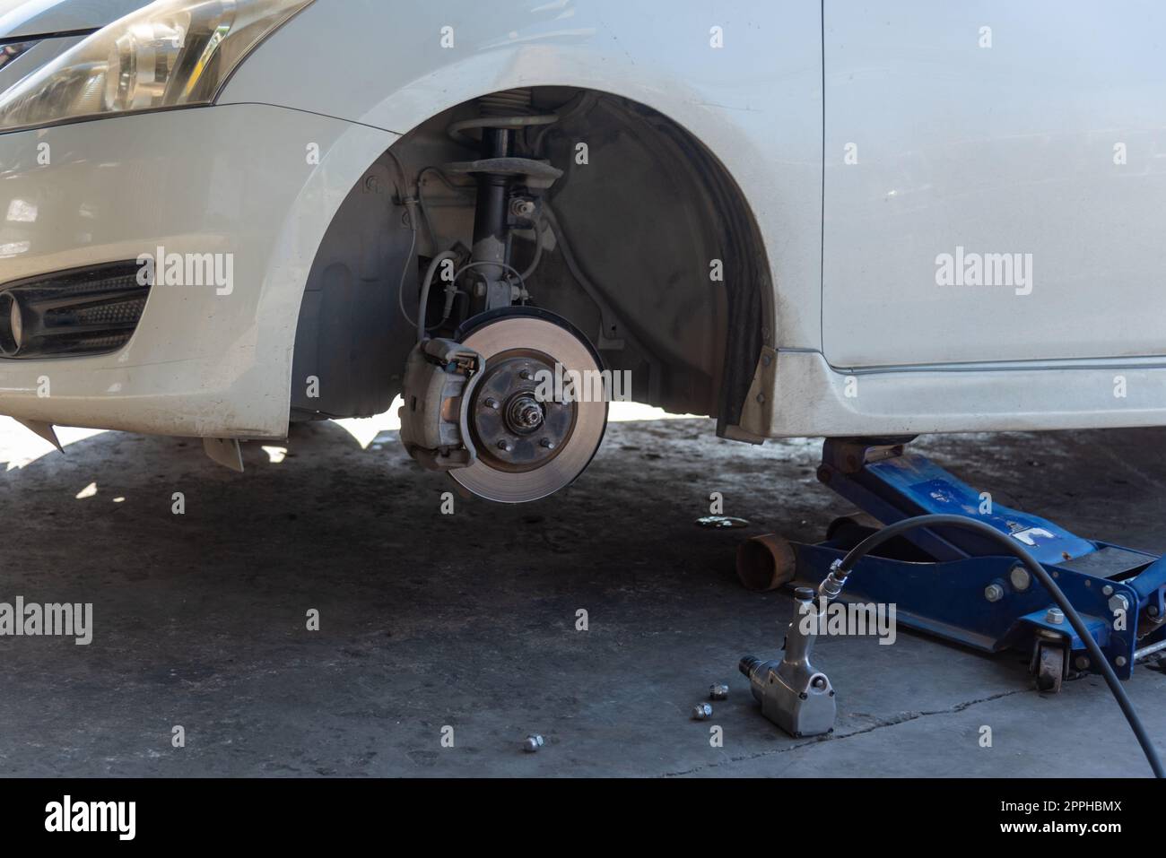 Change a car tire caused by a flat tire by using a jack to lift the car ...