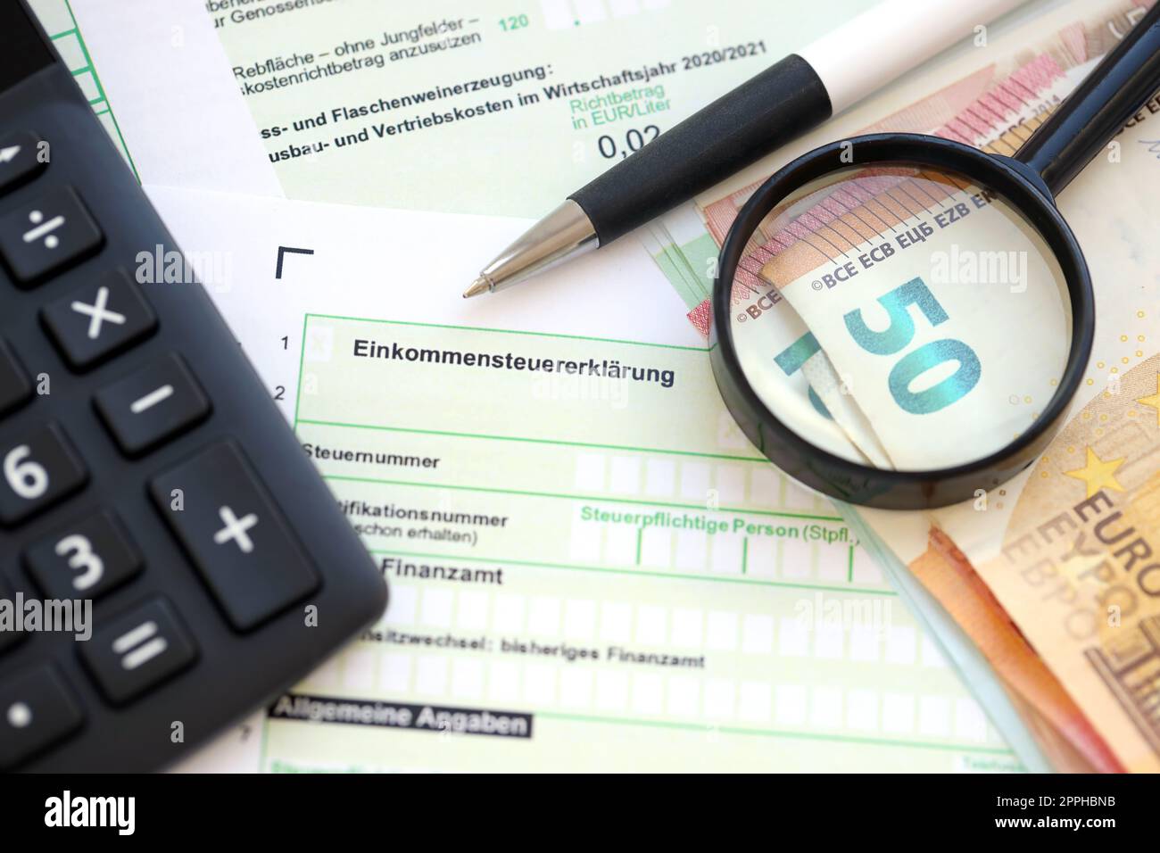 German income tax return form with pen and european euro money bills ...