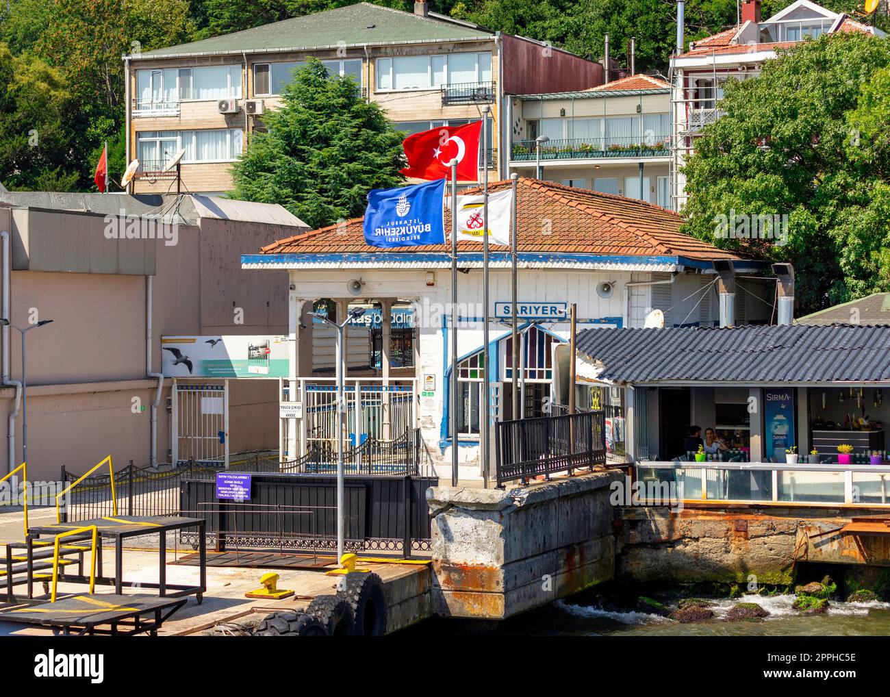 Bosphorus Strait, Sariyer Ferry Terminal with dense green trees in the ...