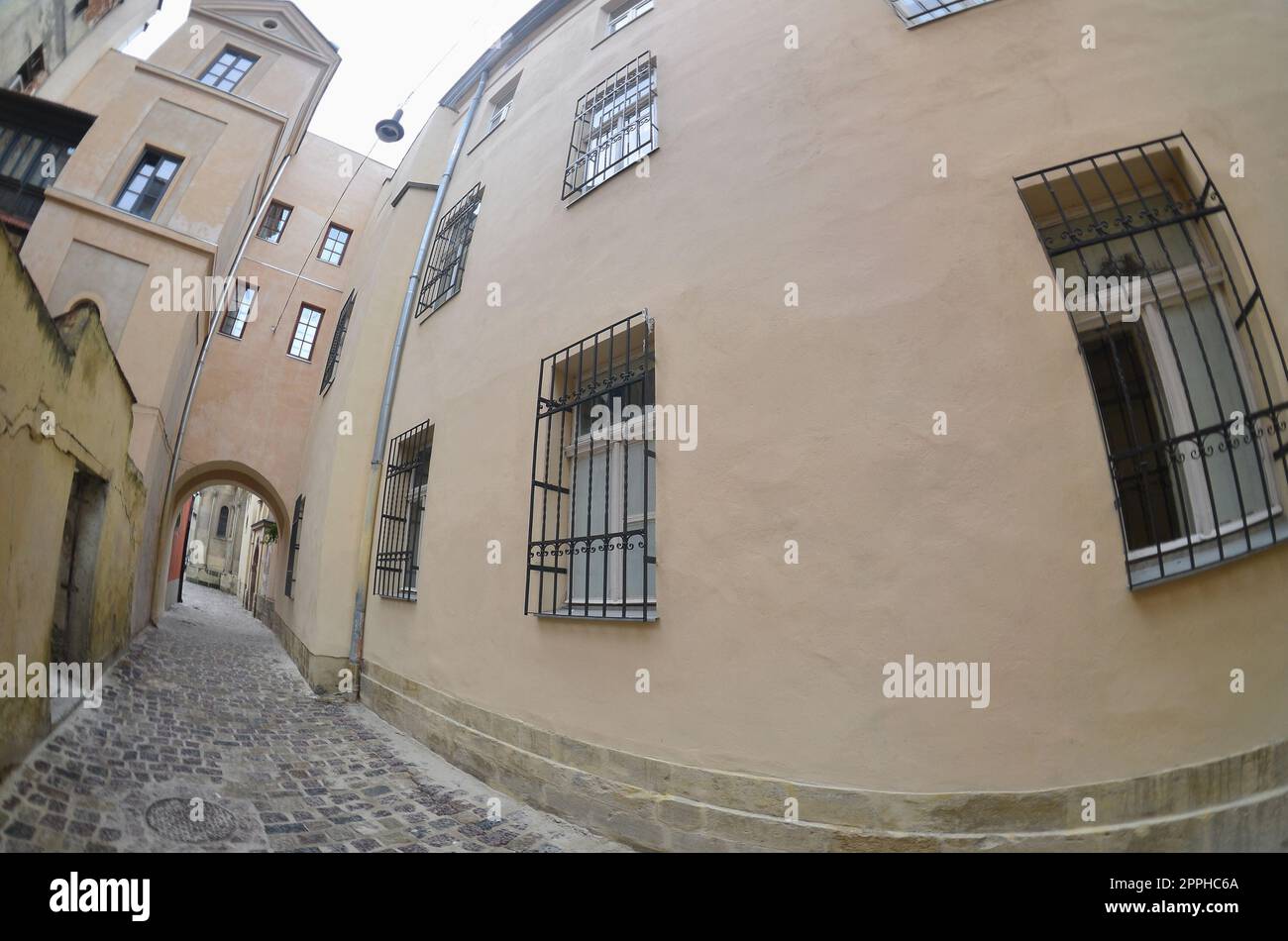 Narrow street with a path of paving stones. Passage between the old ...