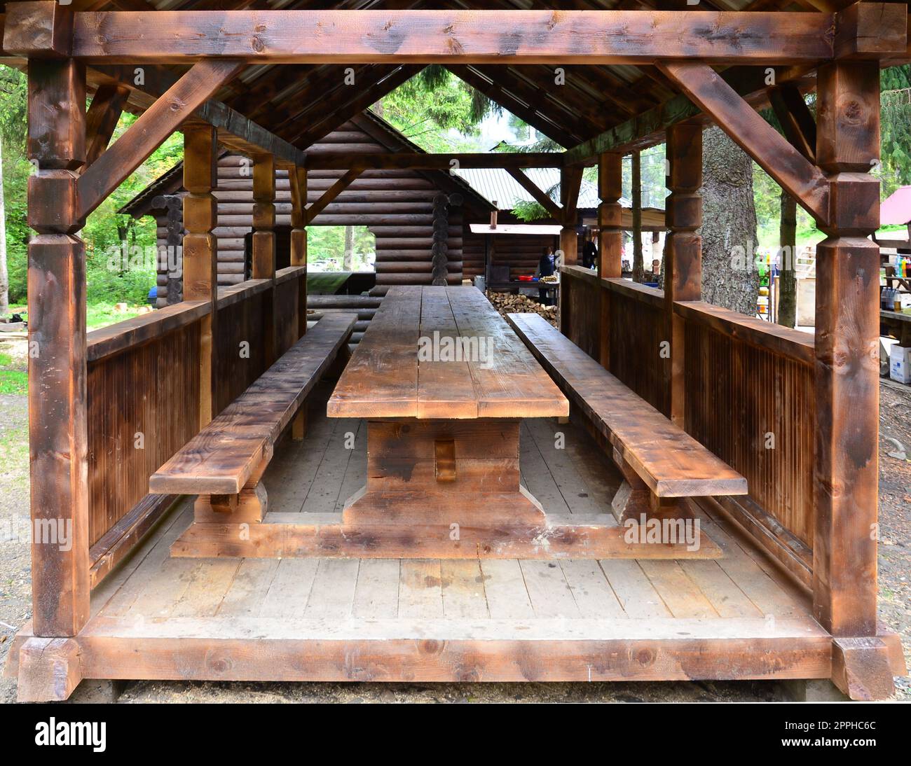 Interior of a wooden arbor handmade from dark wood in the woodland ...