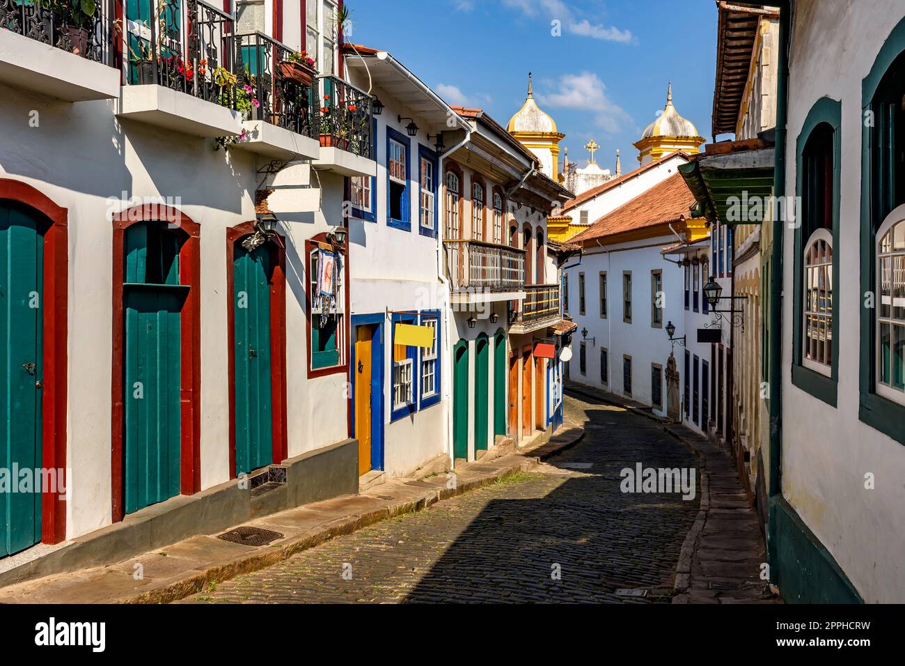 Bucolic street with old colonial-style houses and cobblestones in Ouro ...