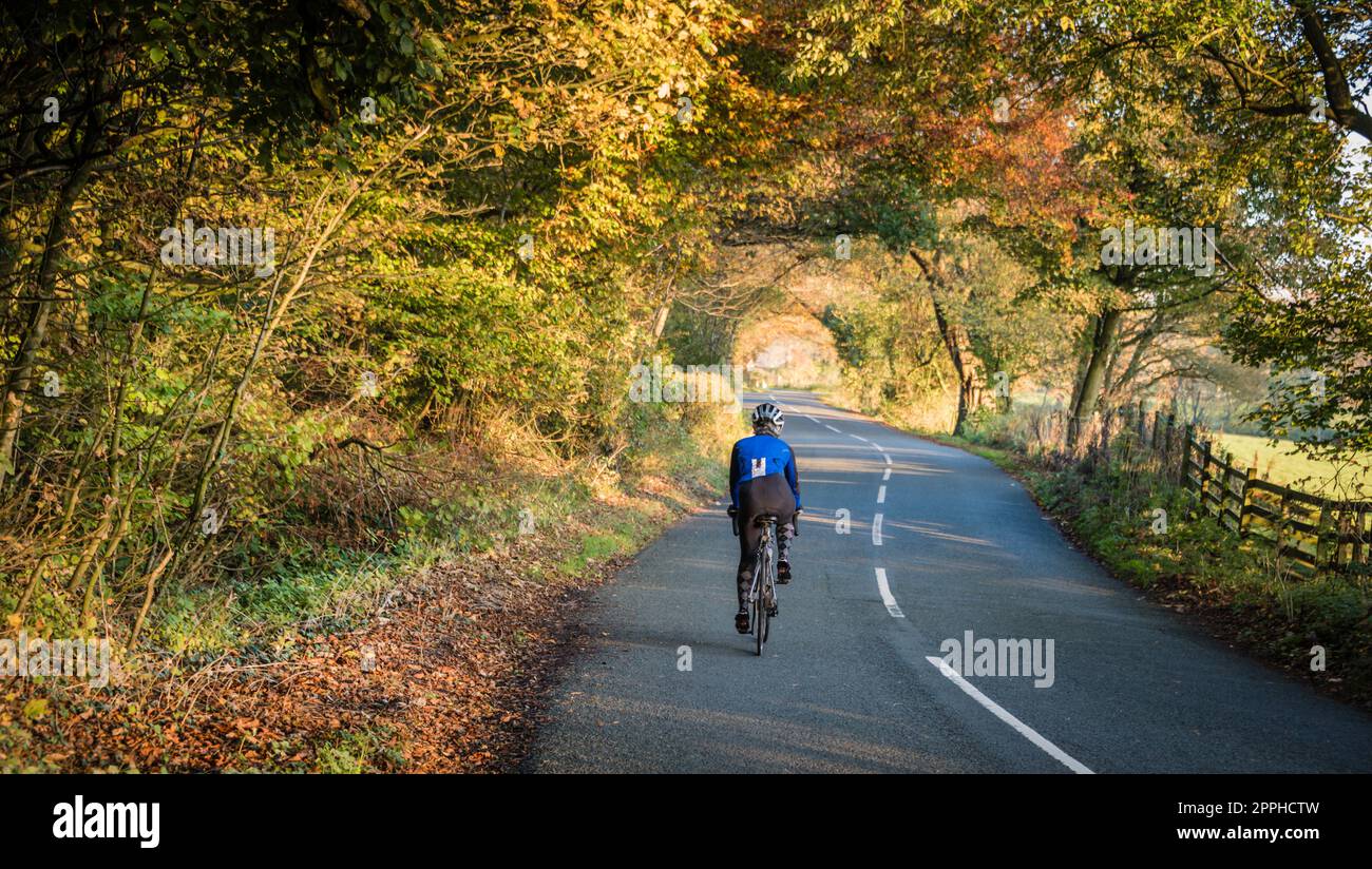 Female road cyclist on the autumnal roads of Whitewell, Bowland ...