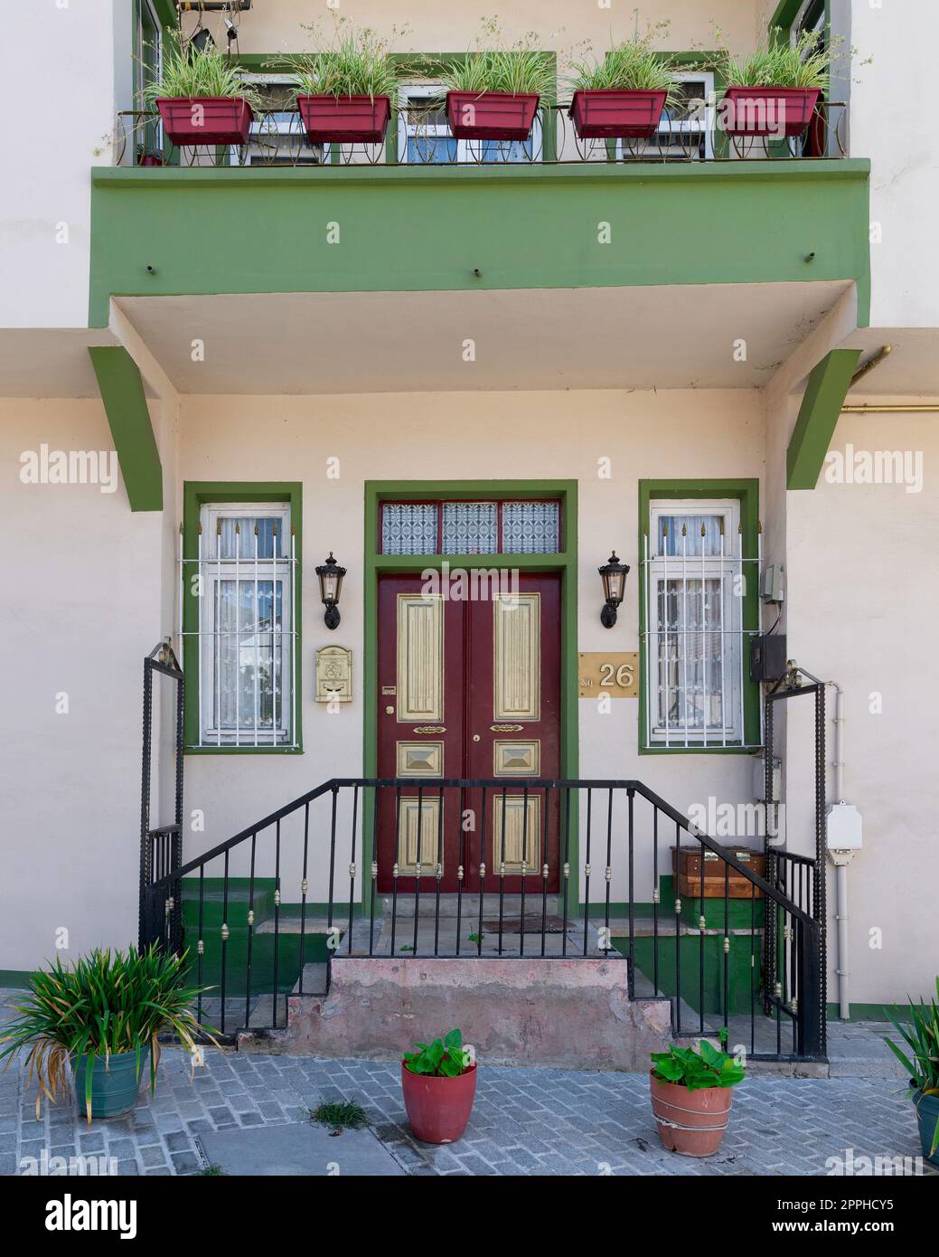 Old colorful wooden residential building with door, wrought iron ...
