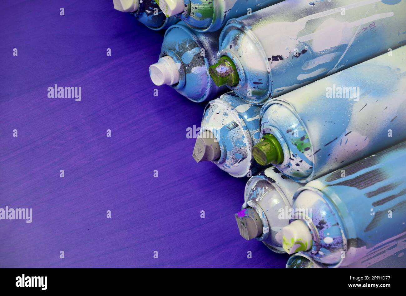 Still life with a large number of used colorful spray cans of aerosol ...