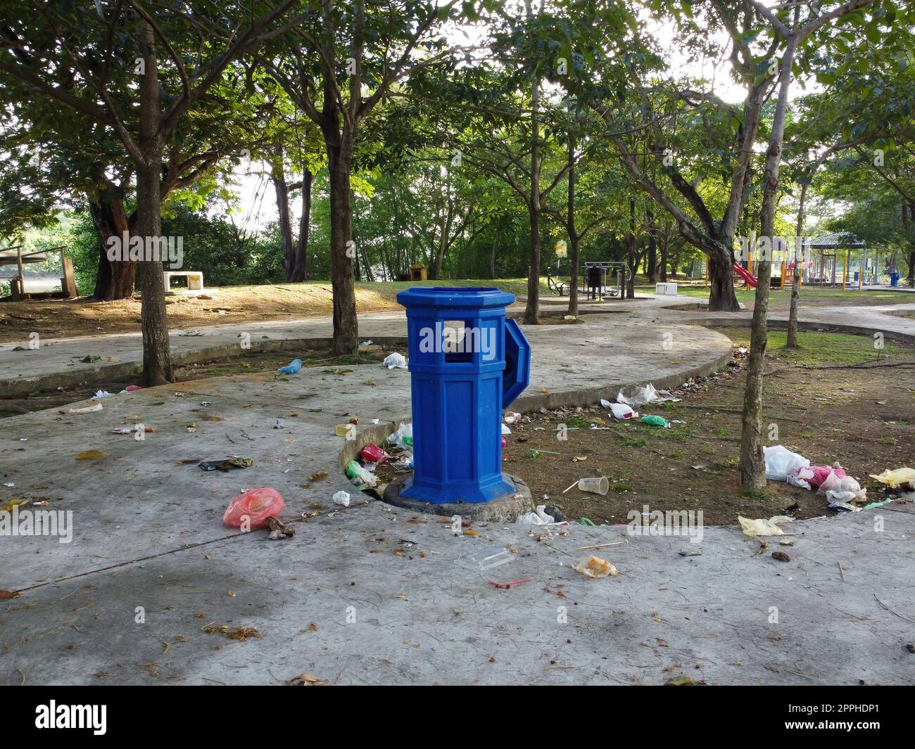Blue dustbin at the park Stock Photo - Alamy