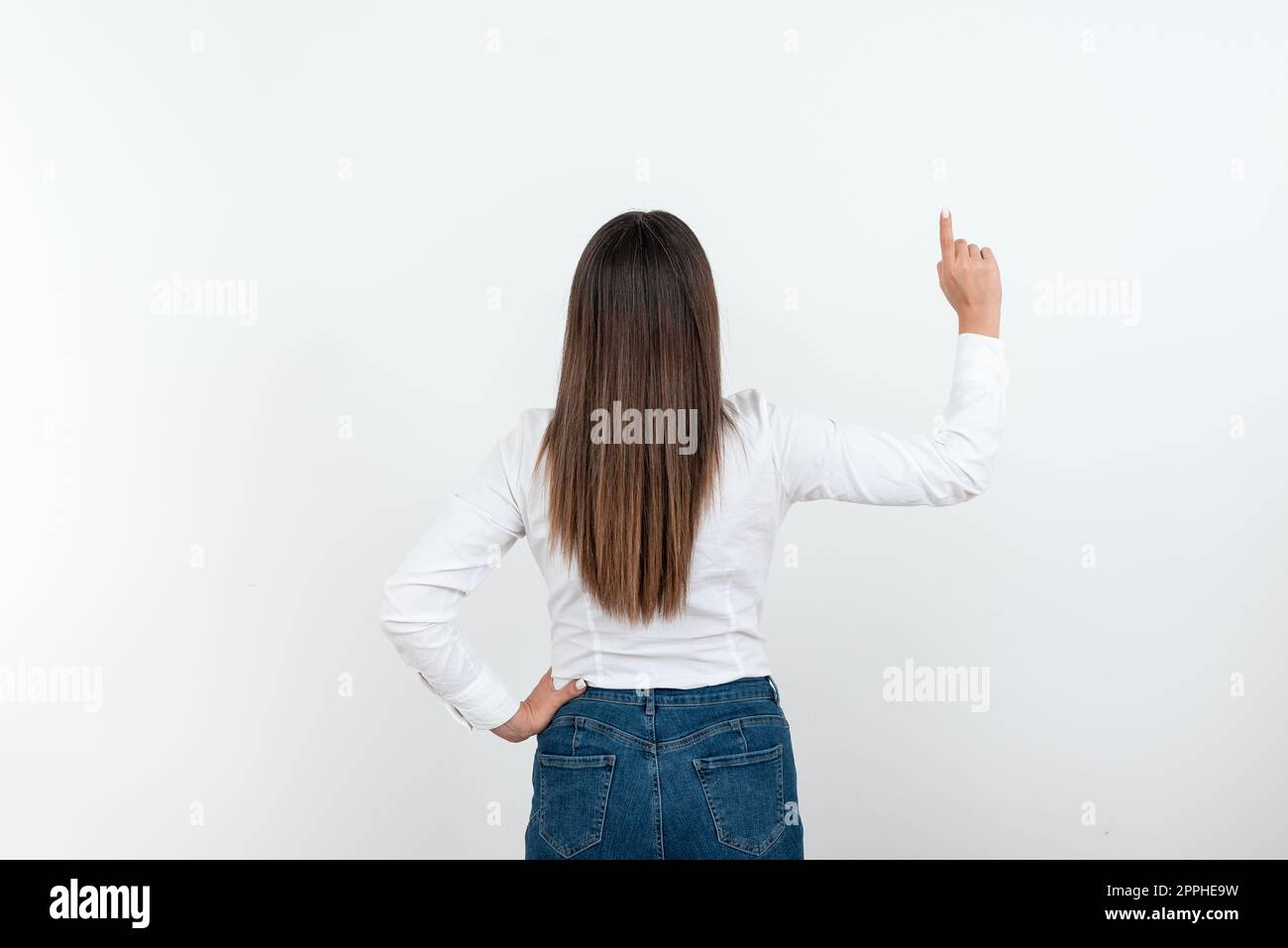 Portrait young woman pointing backwards hi-res stock photography and ...