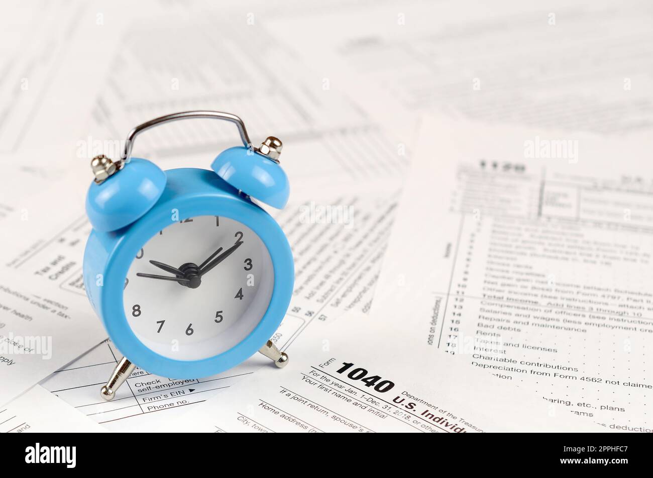 1040 Individual income tax return form and blue alarm clock Stock Photo ...