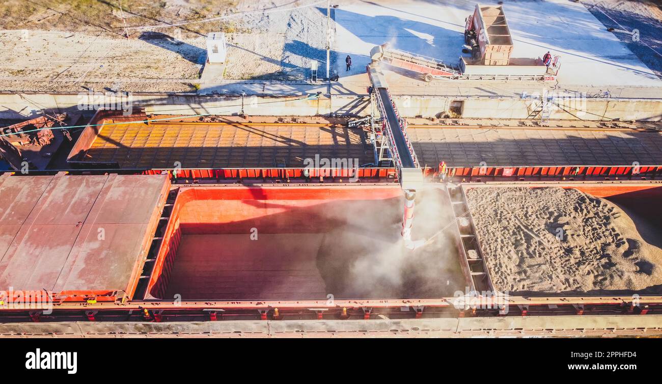 Russians loading grain into holds of sea cargo vessel through an ...