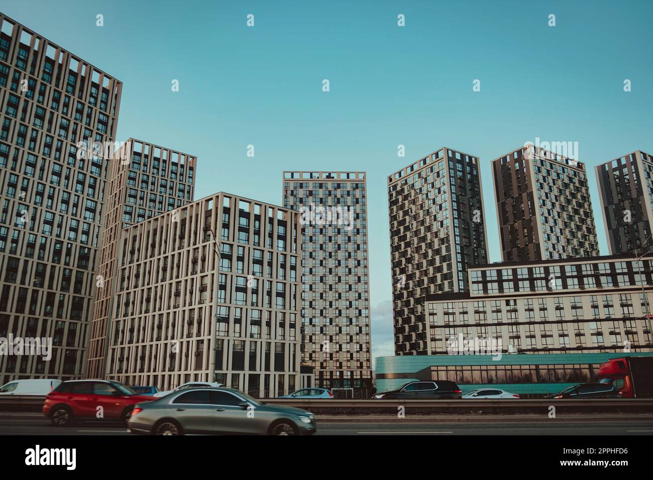 Bottom view of modern skyscrapers in business district against blue sky ...