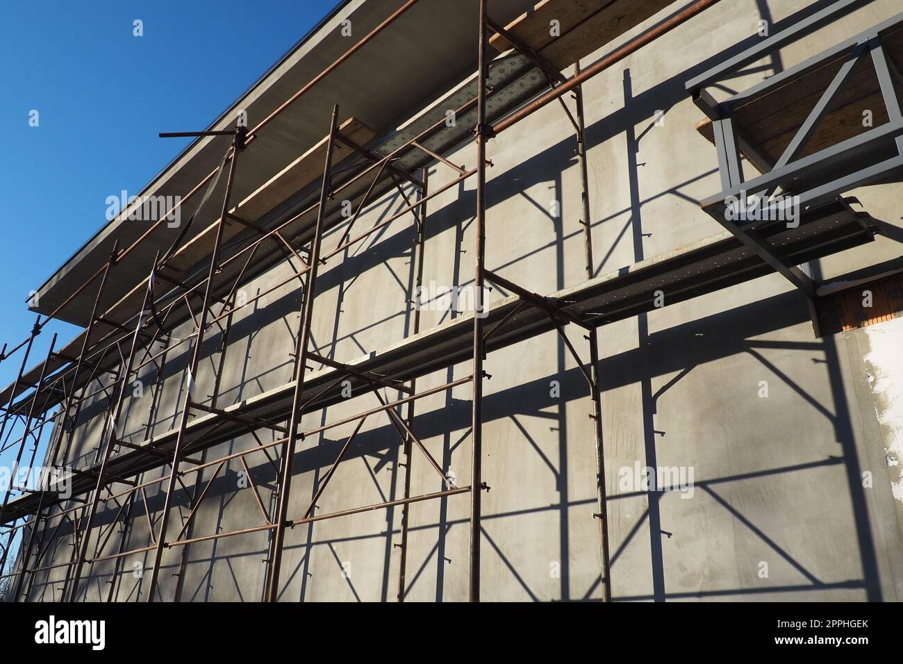 Scaffolding on a new one-story house. Facade works. Building bussiness ...