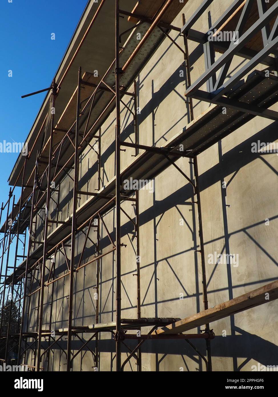 Scaffolding on a new one-story house. Facade works. Building bussiness ...