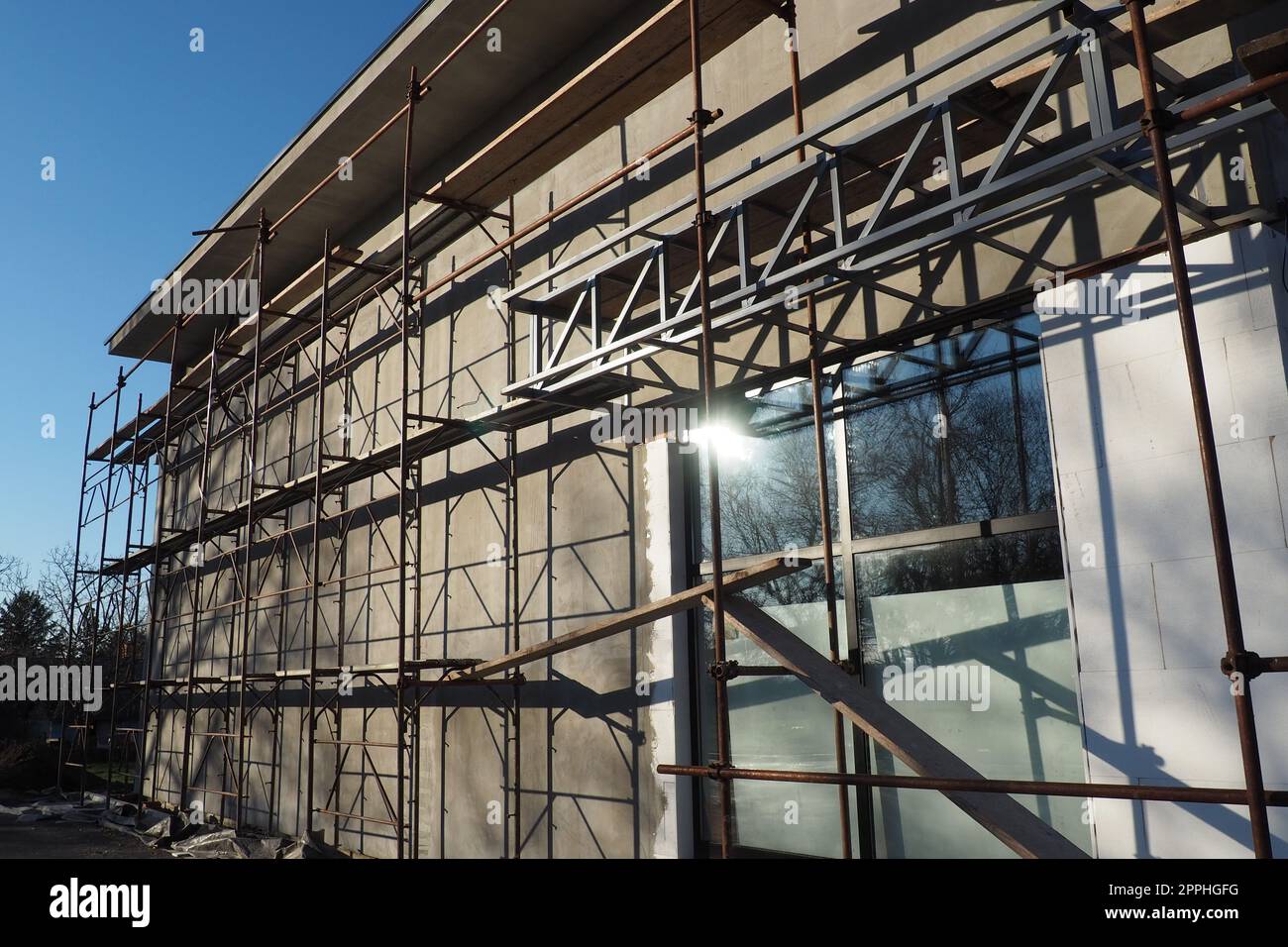 Scaffolding on a new one-story house. Facade works. Building bussiness ...
