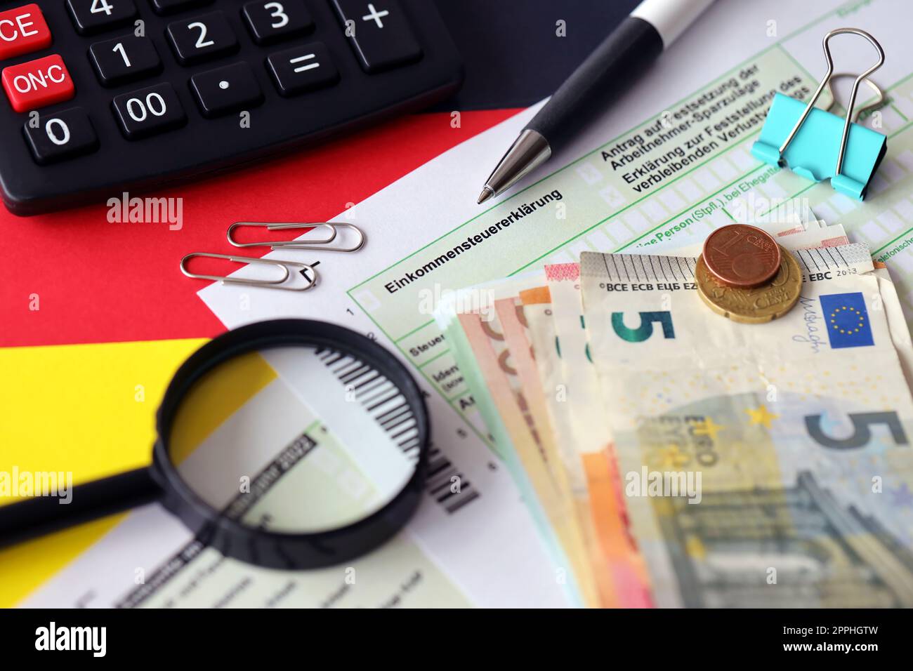 German income tax return form with pen and european euro money bills ...