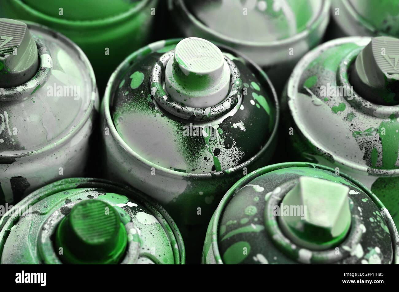 A lot of used spray cans of paint close-up. Dirty and smeared cans for ...