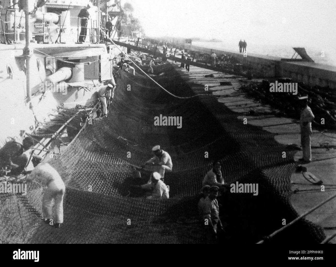 Fitting torpedo nets on a Royal Navy ship, early 1900s Stock Photo - Alamy