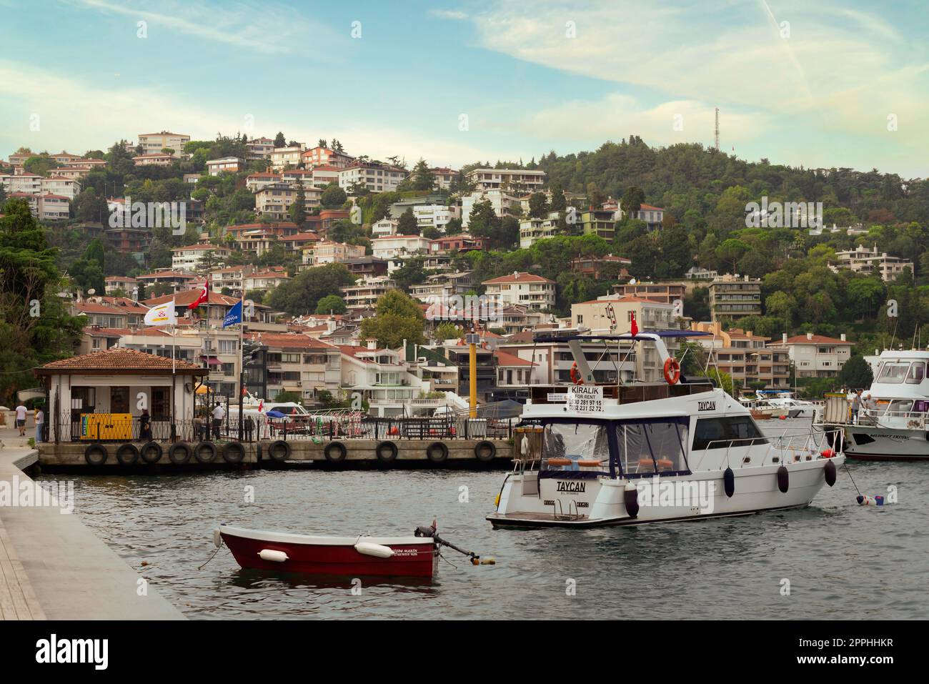 Green mountains of the European side of Bosphorus, and docked boats at ...